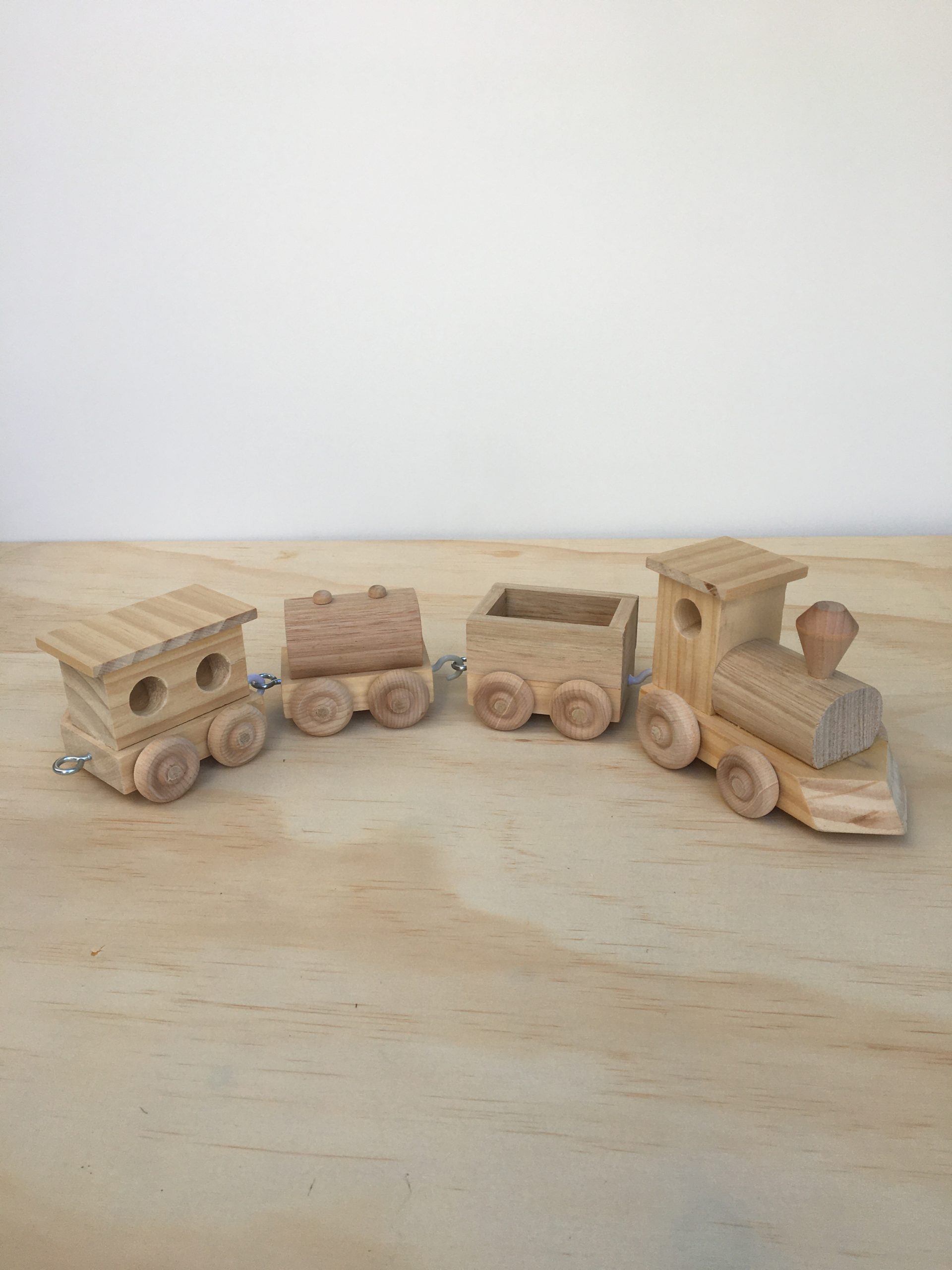 Wooden toy train set with steam locomotive and three carriages ...